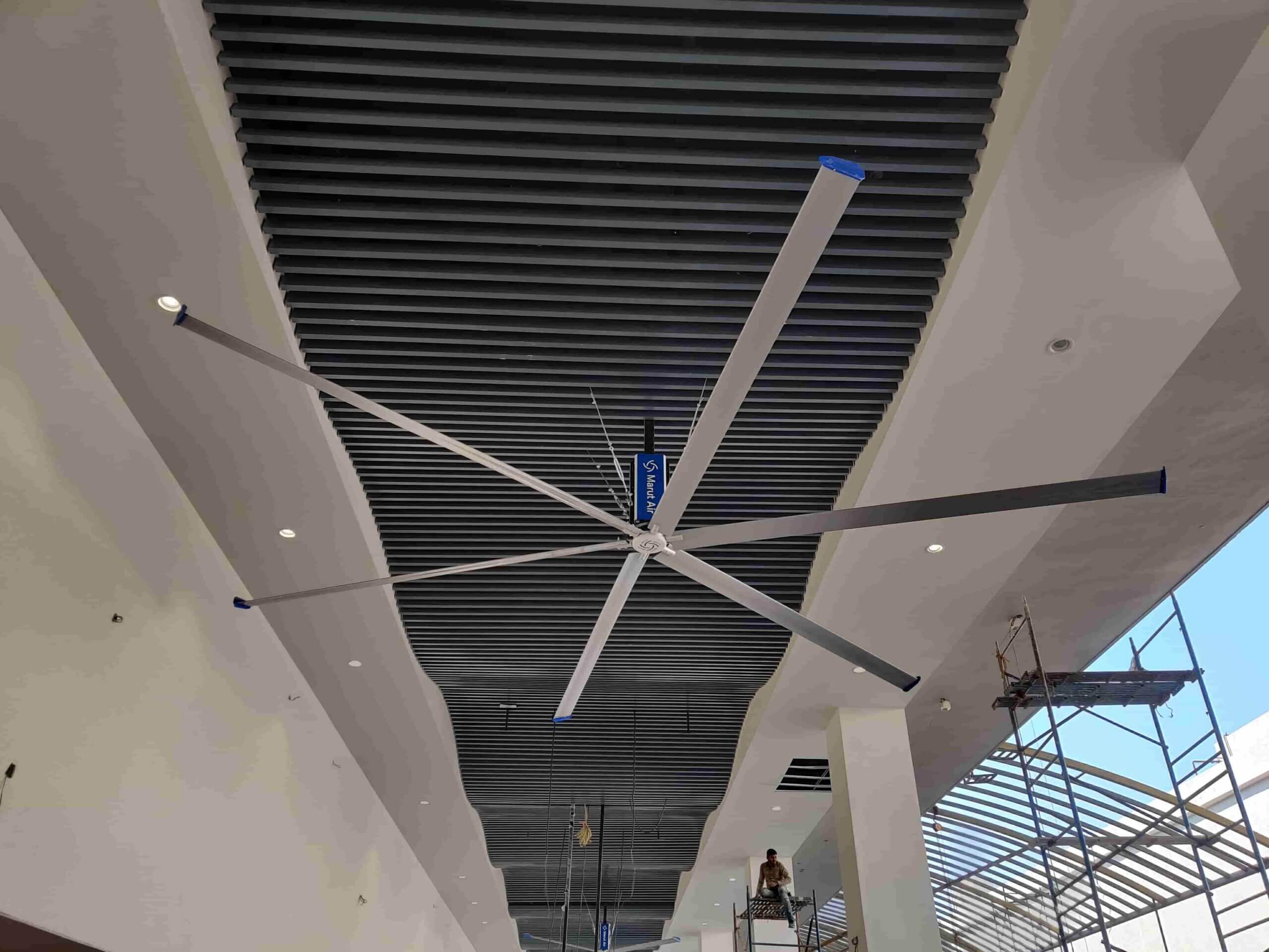 Why use large fans to control the temperature in commercial settings?